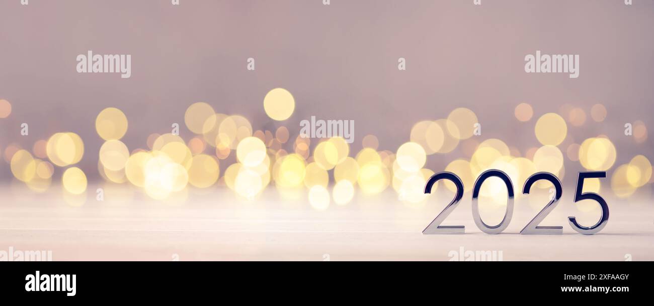 Metal numbers 2025 on table with bokeh lights Stock Photo - Alamy