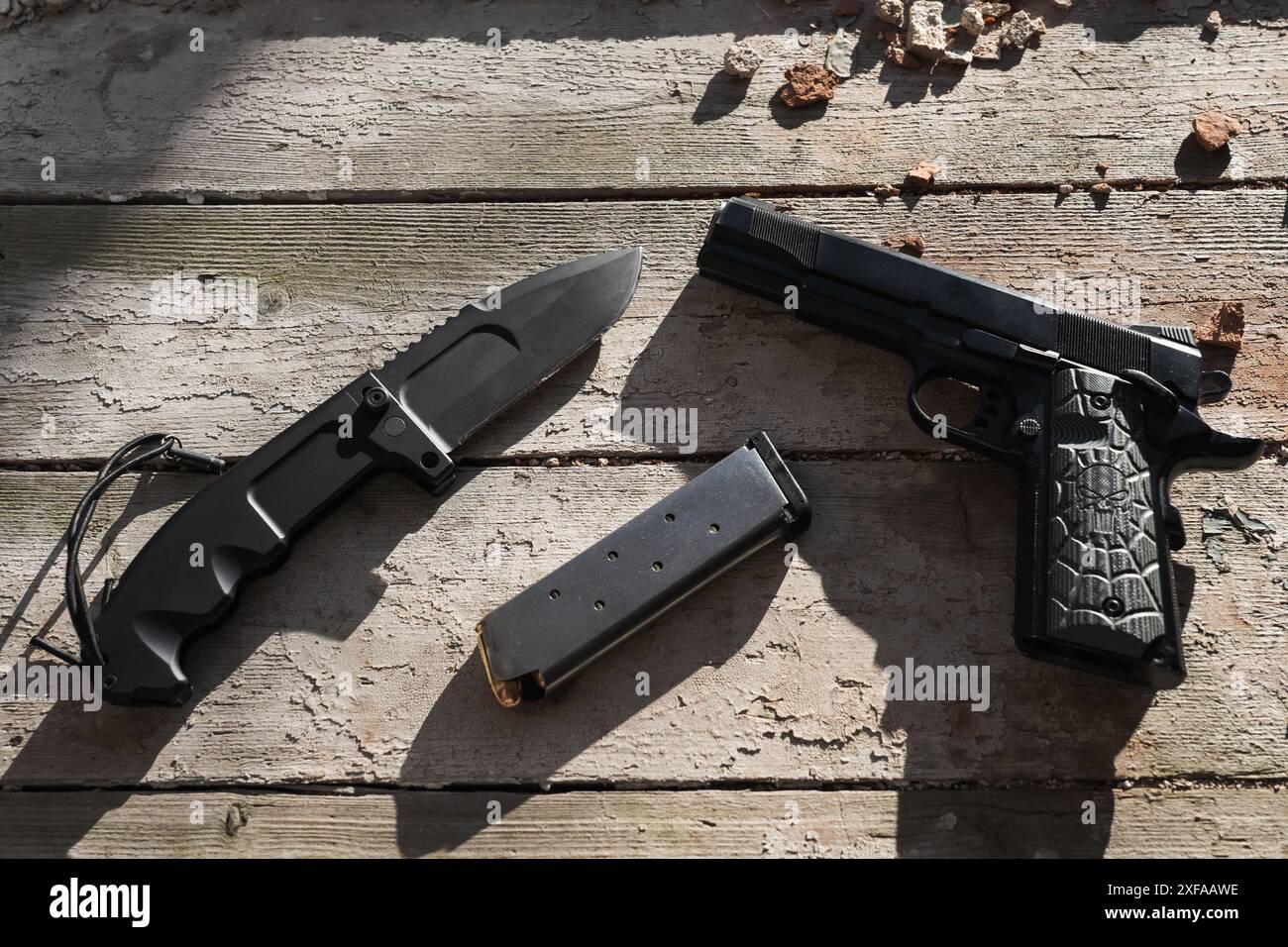 Firearms and bladed weapons, an M1911 pistol, a magazine with ...