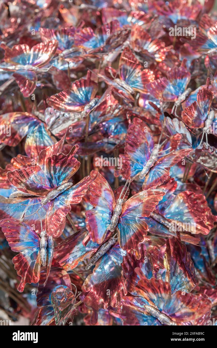 A close-up of colorful metallic butterfly decorations in a cluster ...