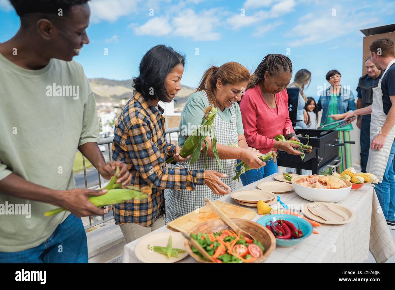Multigenerational people doing barbecue at home's rooftop - Multiracial ...