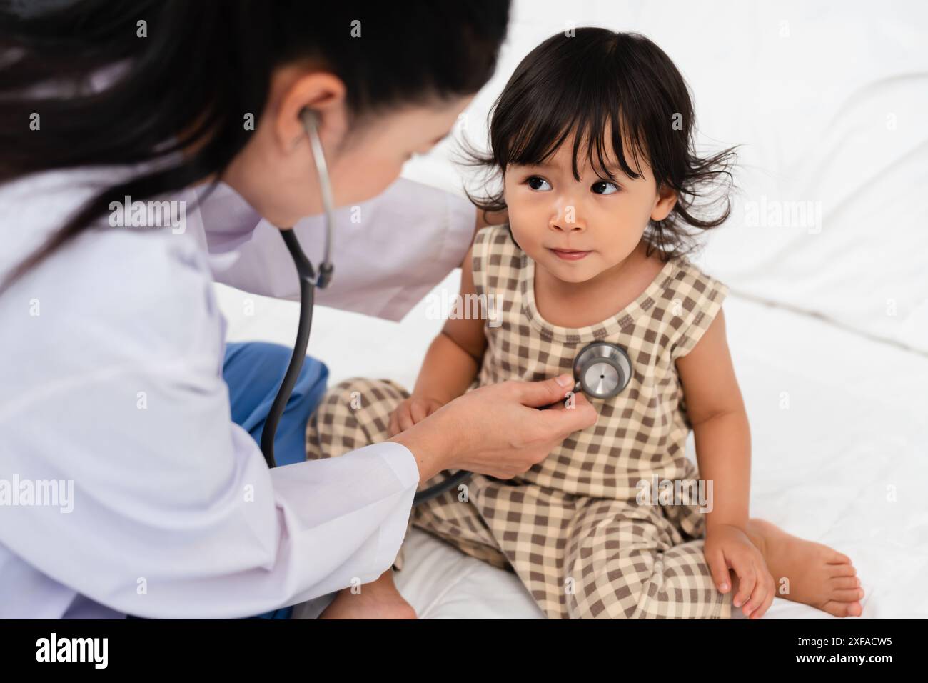 doctor using a stethoscope to istening toddler's chest. baby health ...