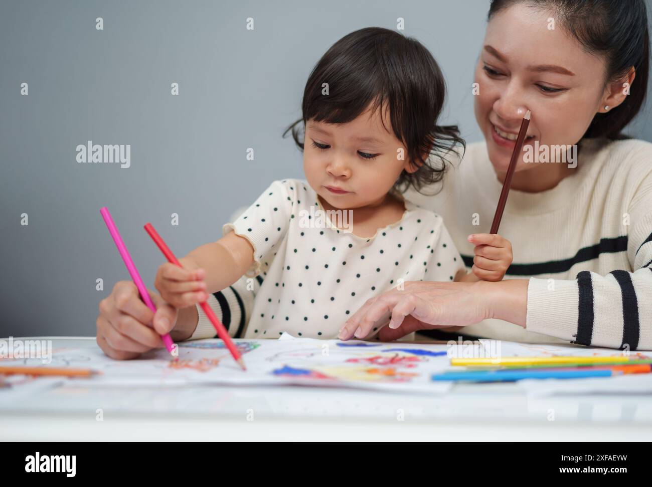 toddler baby training to drawing with colored pencil with mother ...