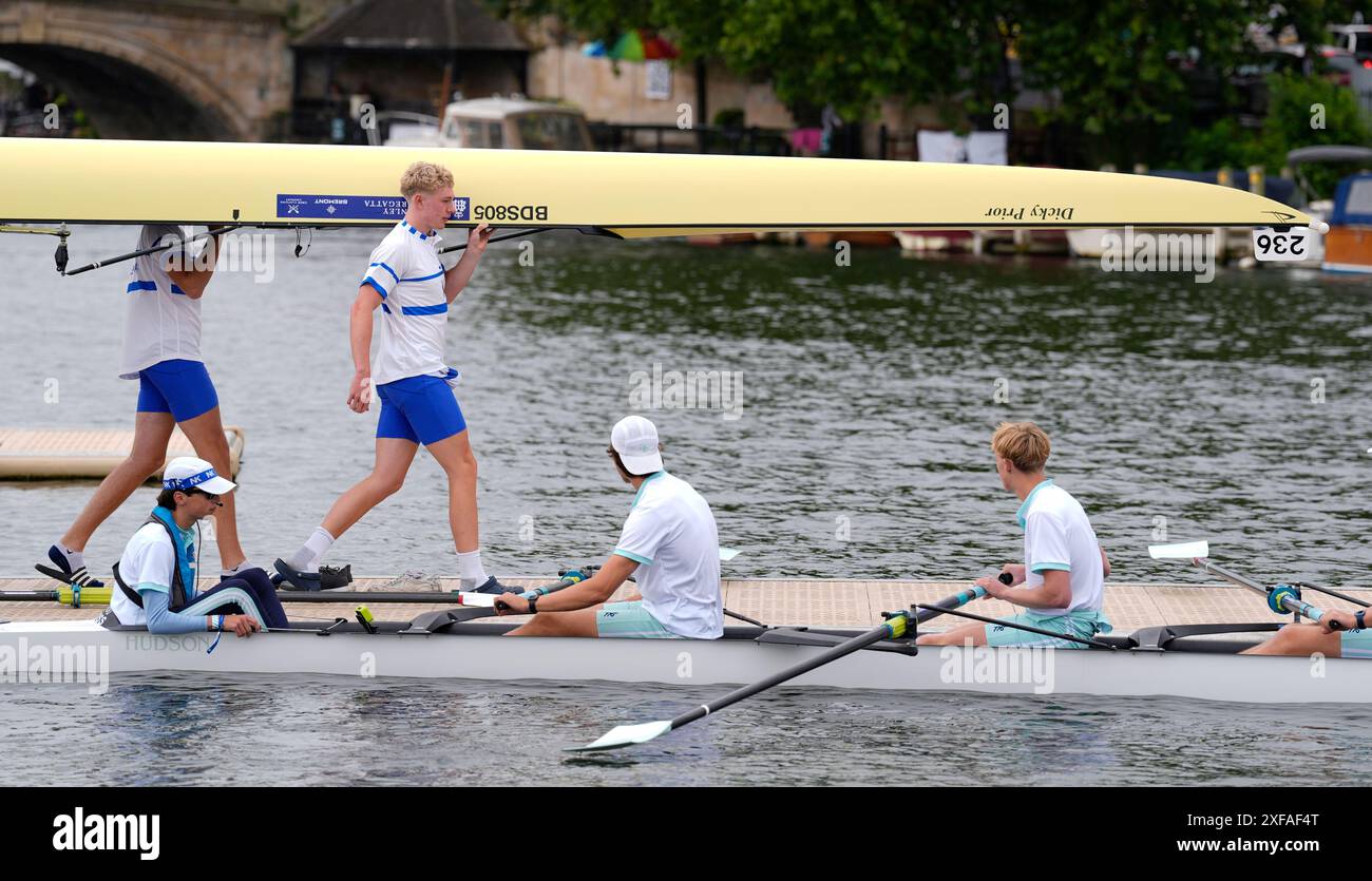 A crew from Bedford School walk out onto a pontoon before heading out ...