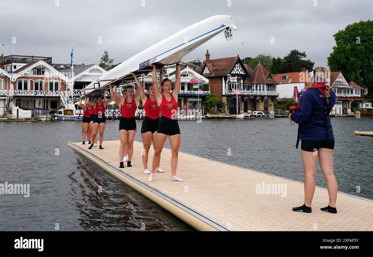 A crew from Marlow Rowing Club carry their boat back to the shed after ...