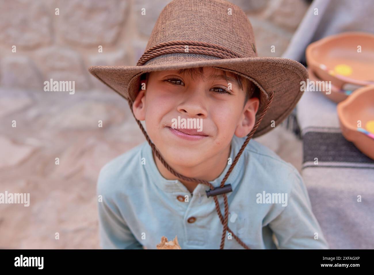 portrait of latino boy face looking at the camera smiling with a cowboy ...