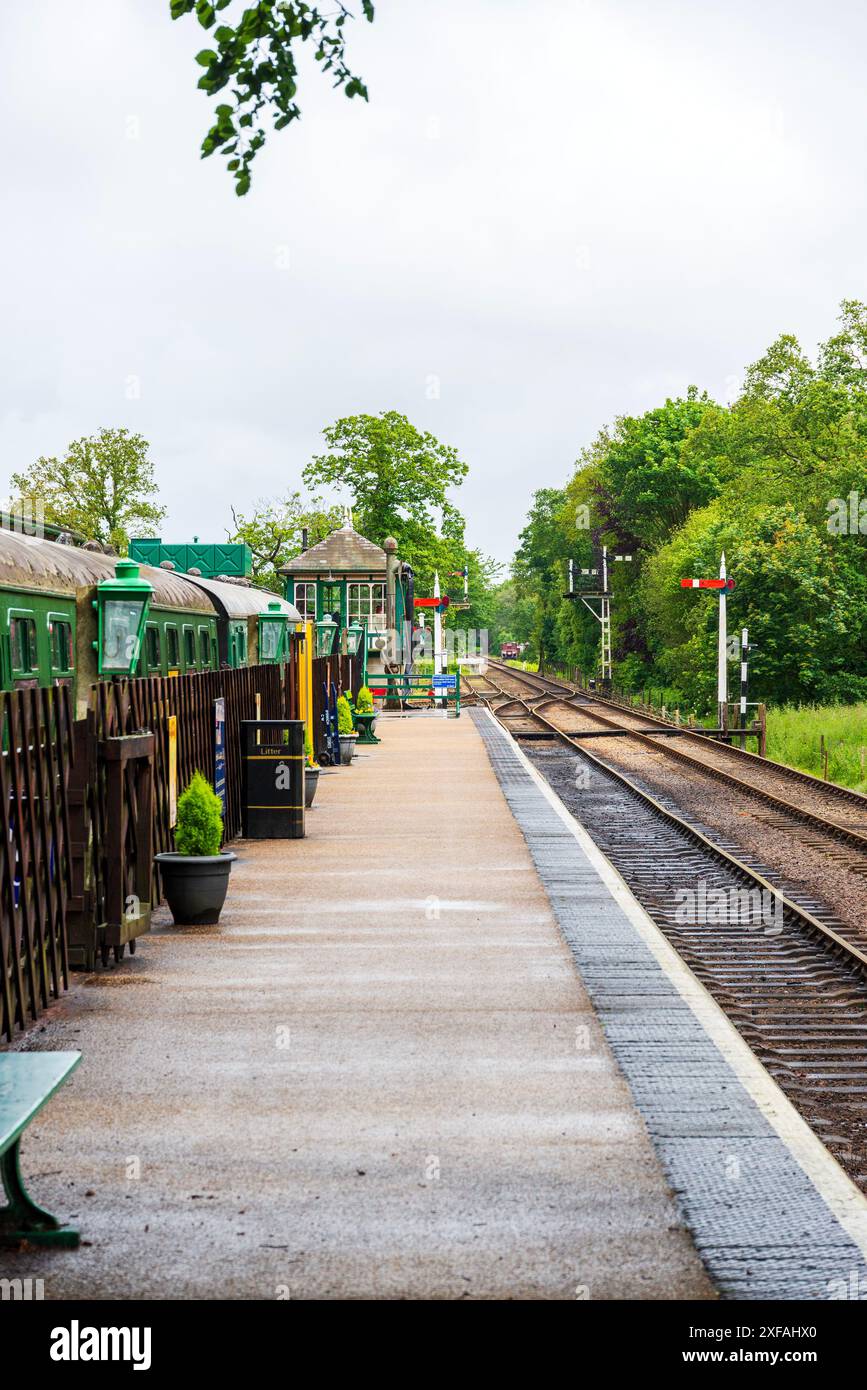 View down Holt railway platform, looking at the railway line and old ...