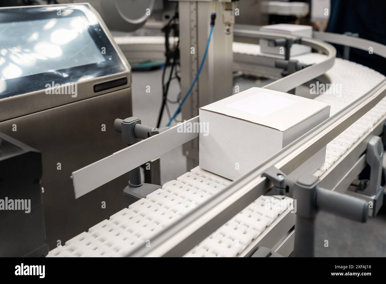 Packed white box with goods on the production line Stock Photo - Alamy