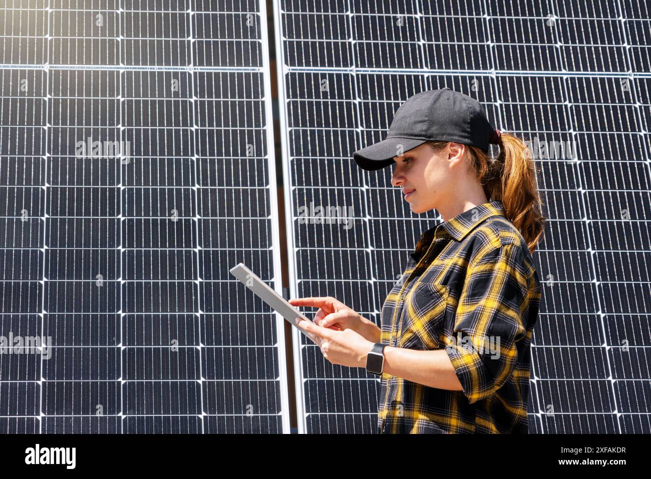 A female engineer performs maintenance on a solar power plant ...