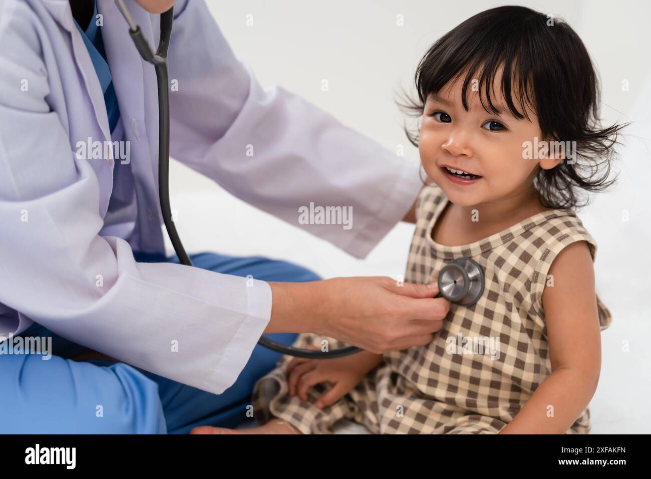 doctor using a stethoscope to istening toddler's chest. baby health ...