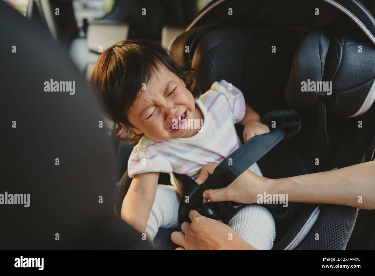 Child crying car seat hi-res stock photography and images - Alamy