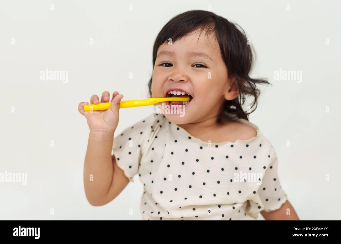 happy toddler girl brushes her teeth with a smile Stock Photo - Alamy