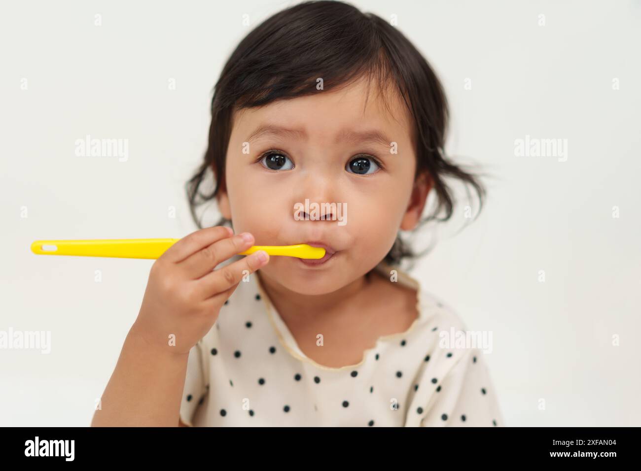 toddler girl brushes her teeth with tooth brush Stock Photo - Alamy