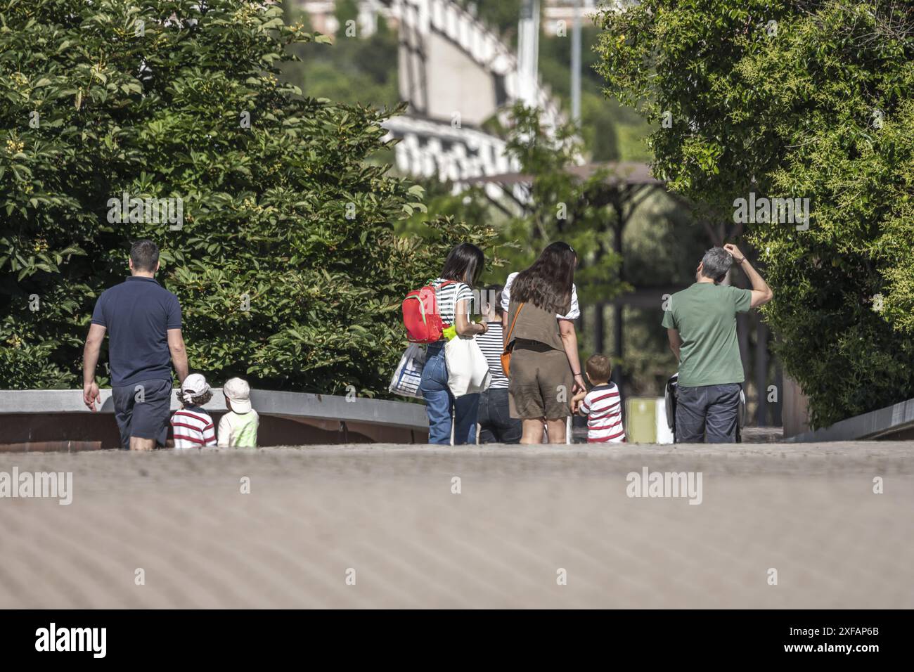urban street, with sidewalks filled with people walking at different ...