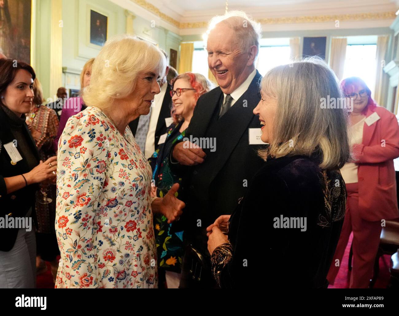 Queen Camilla (left) speaks to Lady Elizabeth McCall Smith (right) and ...