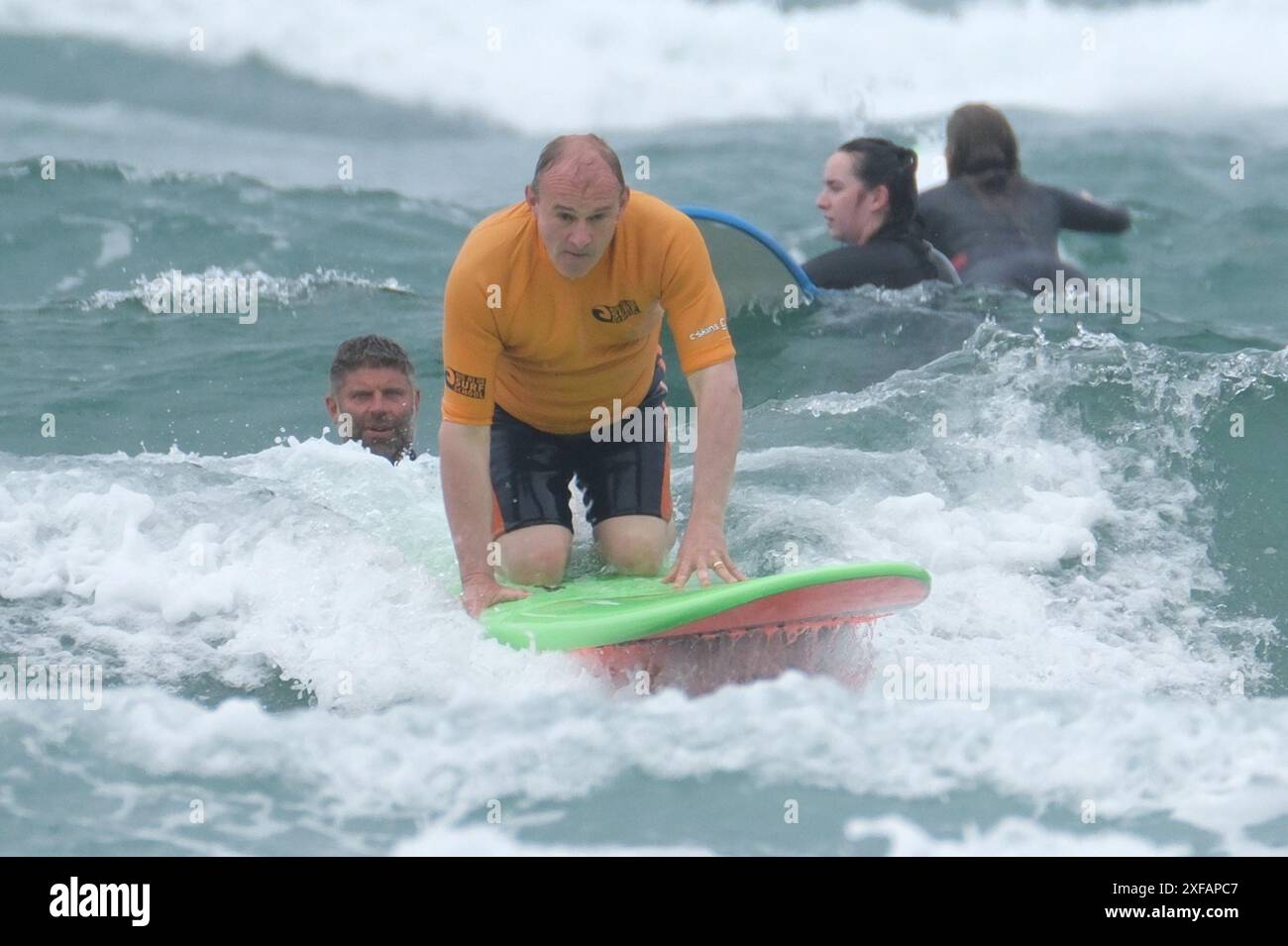 Liberal Democrat leader Sir Ed Davey on a surfboard during a visit to ...