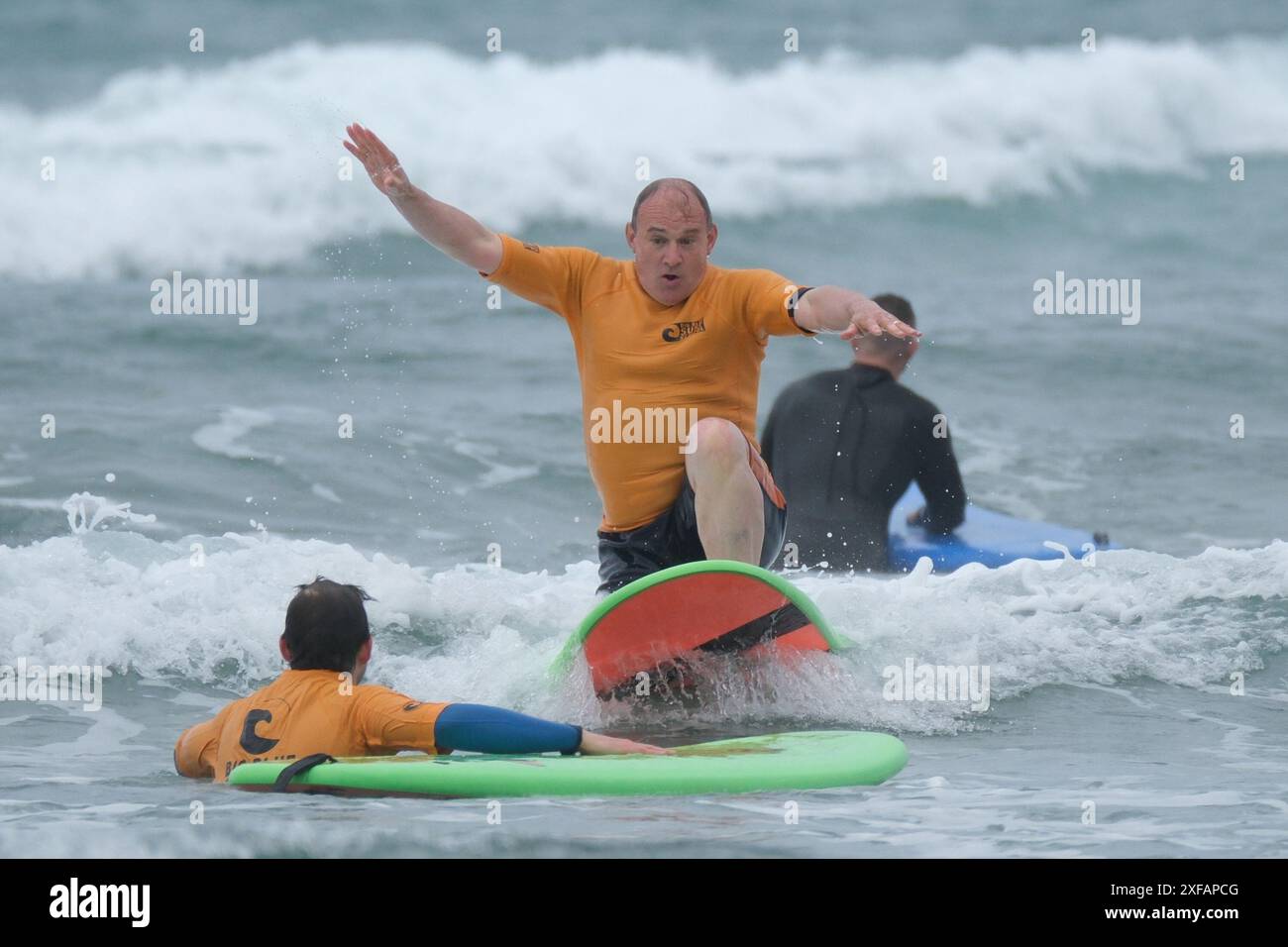 Liberal Democrat leader Sir Ed Davey on a surfboard during a visit to ...