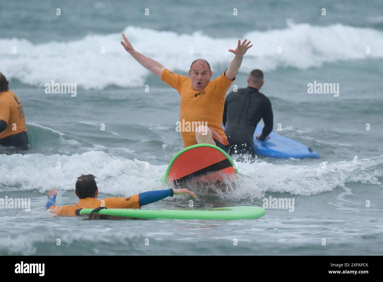 Liberal Democrat leader Sir Ed Davey on a surfboard during a visit to ...