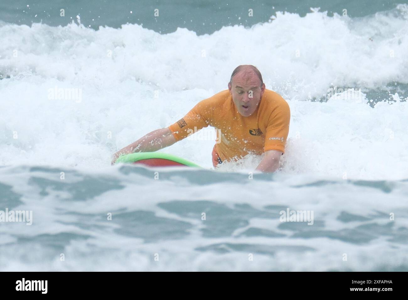 Liberal Democrat leader Sir Ed Davey on a surfboard during a visit to ...