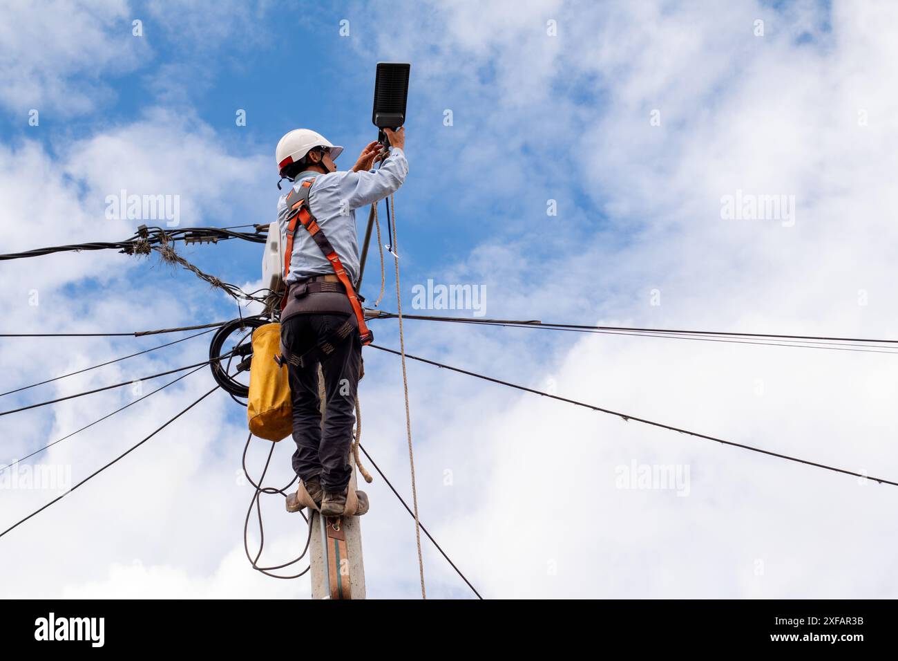 electrical technician performs street lighting maintenance on city ...