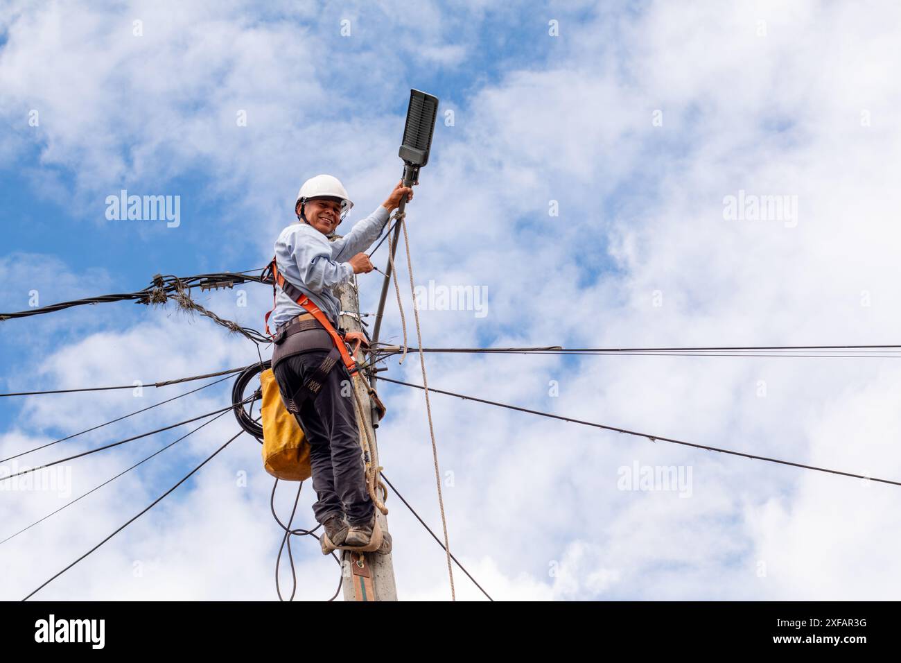 electrical technician is happy to do his job safely Stock Photo - Alamy