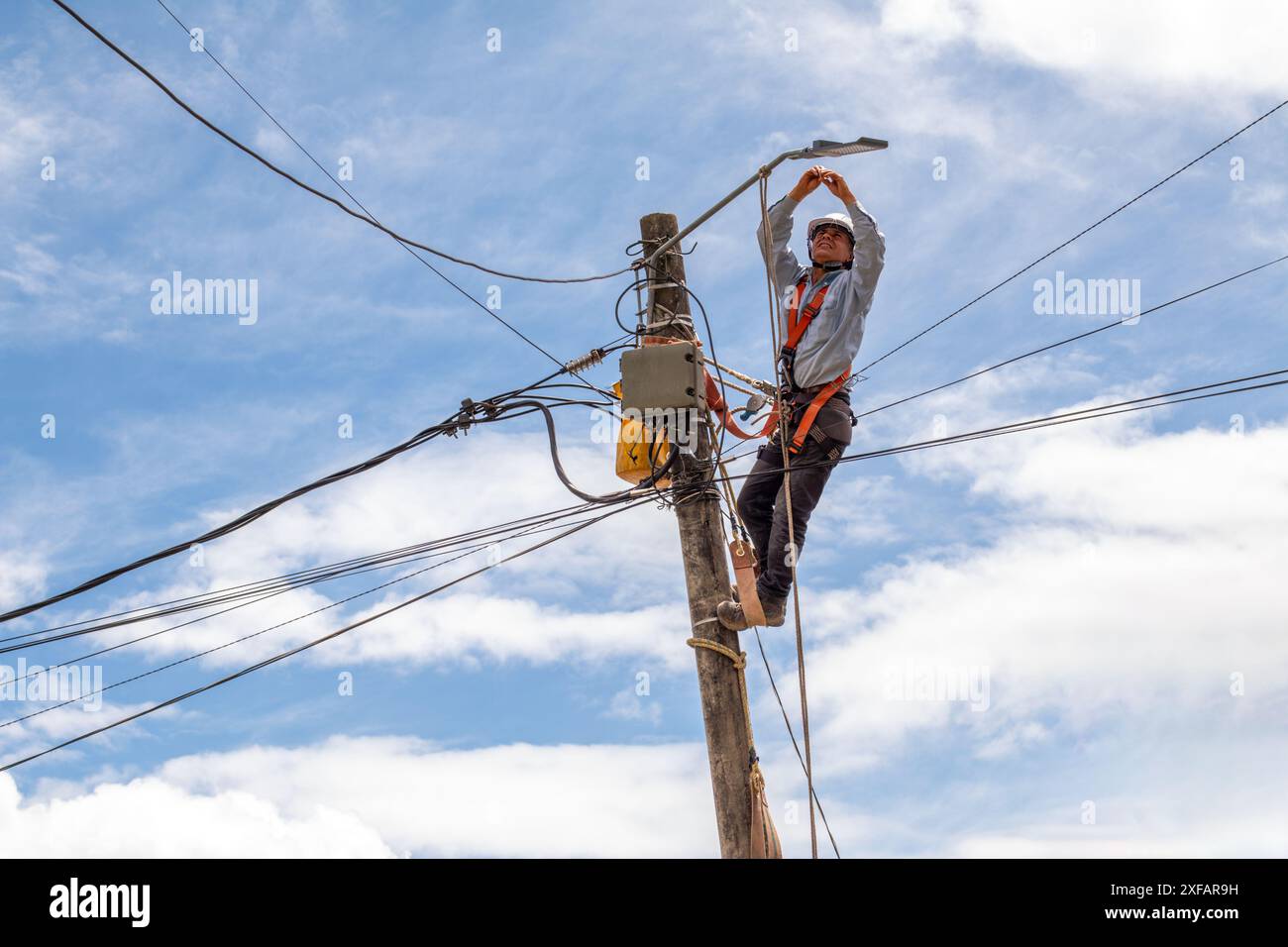 electrician installs new led lighting in the city's public lighting ...