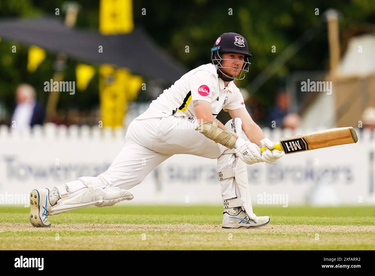 Cheltenham, UK, 2 July 2024. Gloucestershire's James Bracey batting as he hits a 4 to bring up ...