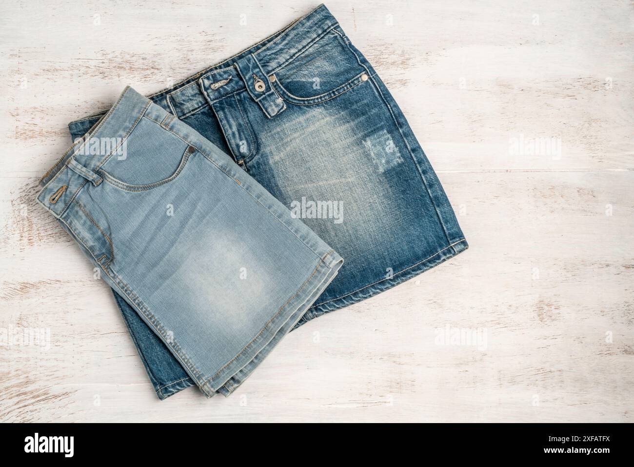 folded jean skirts on a wooden background with copy space Stock Photo ...