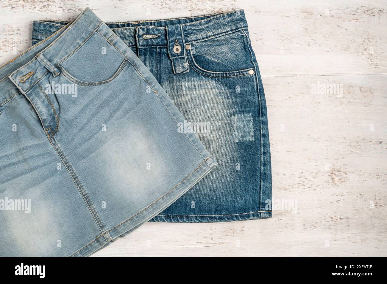 folded jean skirts on a wooden background with copy space Stock Photo ...