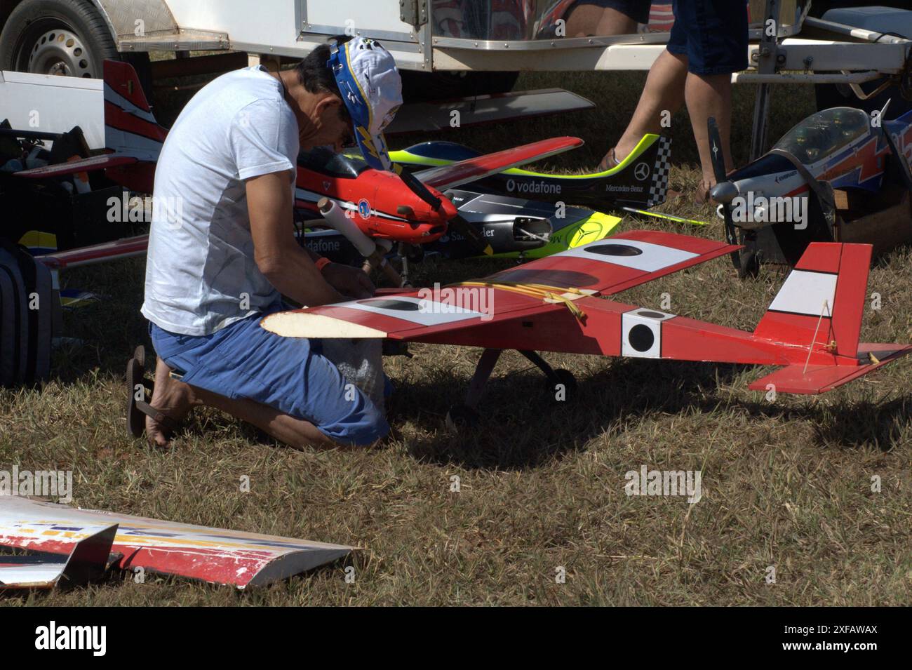 Man with model airplane making adjustments for flight Stock Photo - Alamy