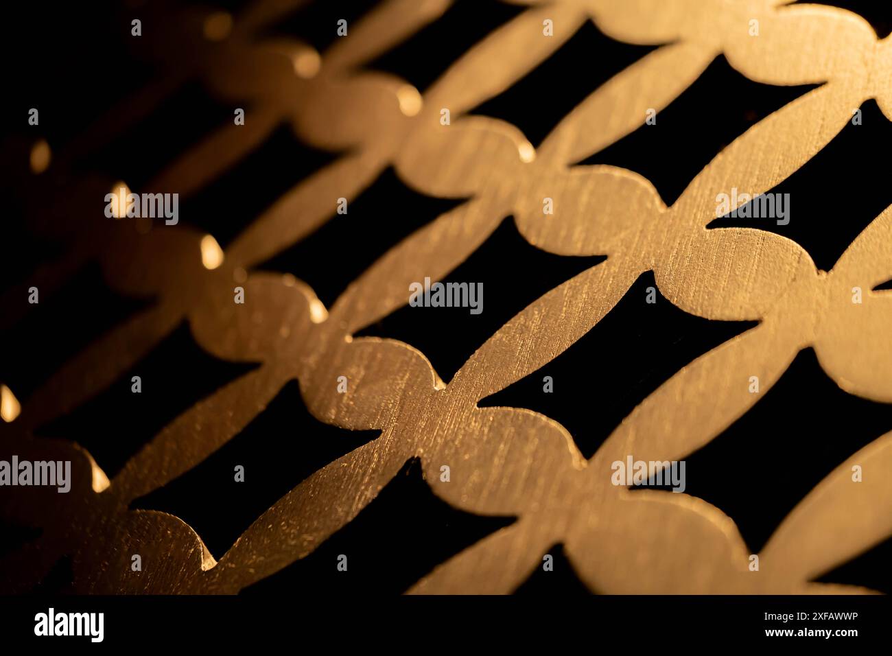Close-up of a golden metallic pattern with interlocking shapes ...