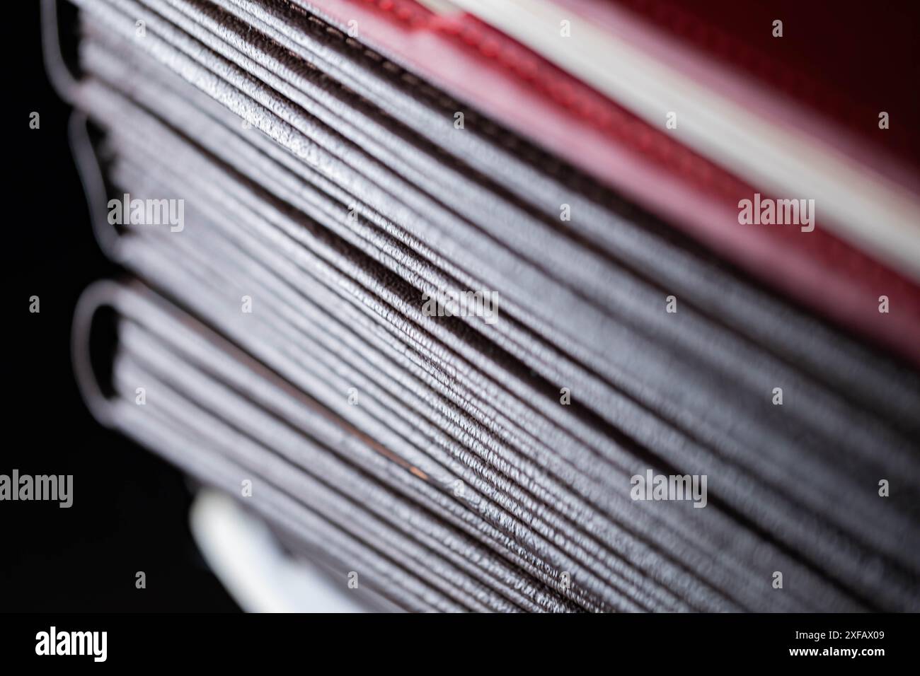 Close-up of a stack of books with visible spines and red covers Stock ...