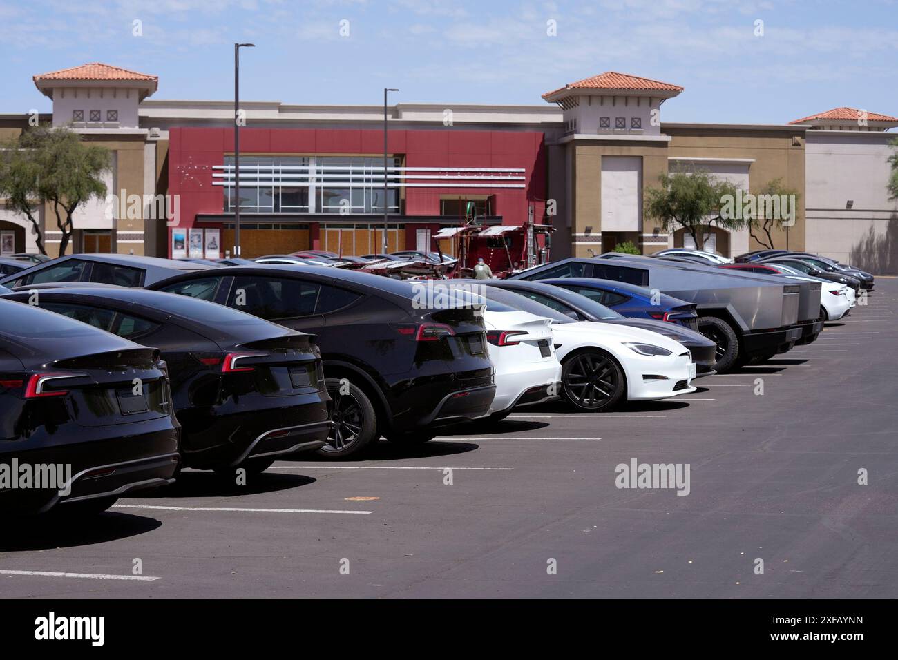 Tesla vehicles are stored at a shopping mall parking lot near a closed ...