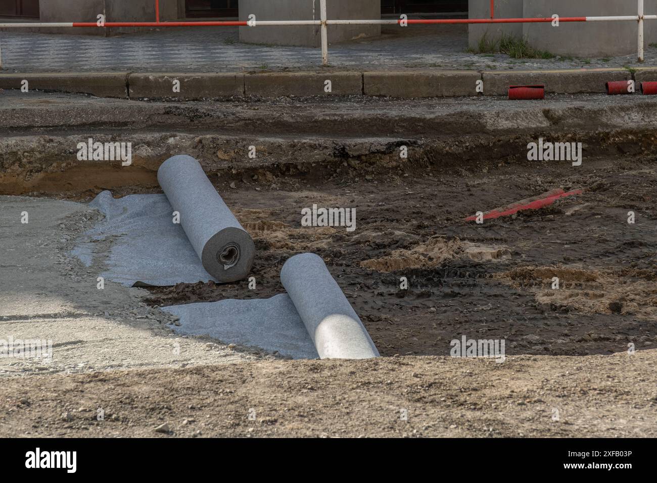 A roll of geotextile is laid on road construction. layer of Modern road ...