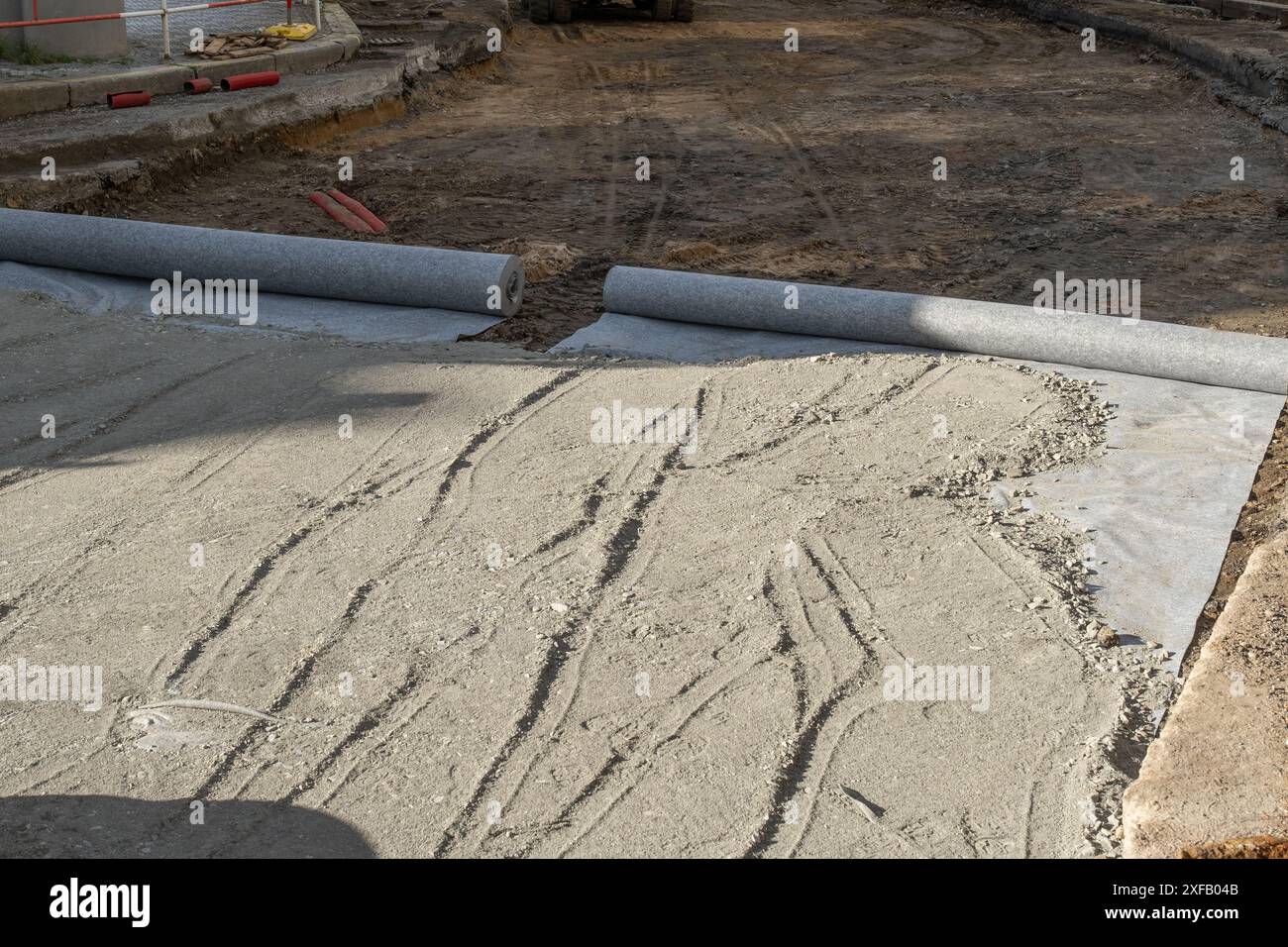 A roll of geotextile is laid on road construction. layer of Modern road ...