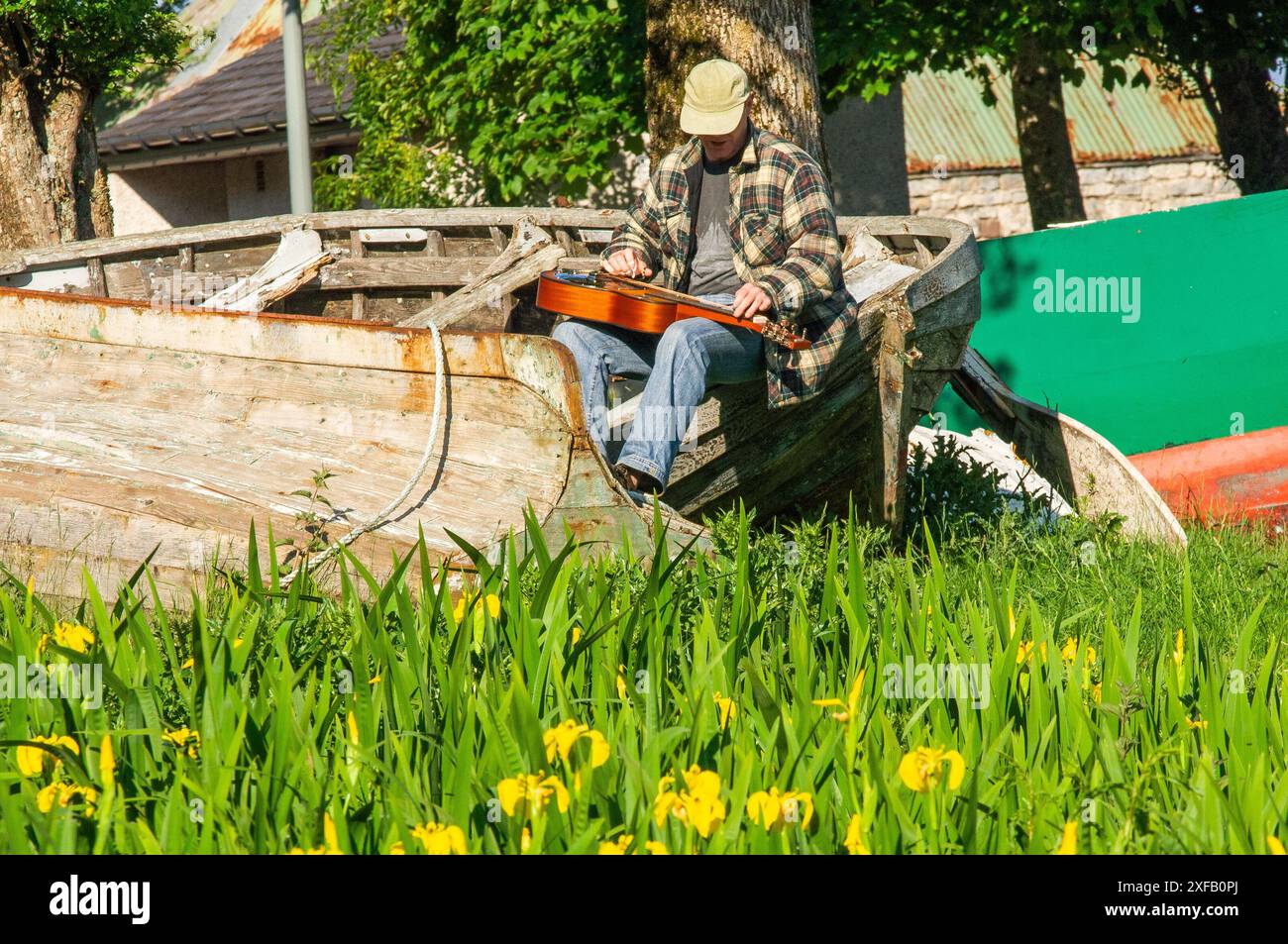 Robin Clark owner of Busker Guitars plays one of Busker guitars ...