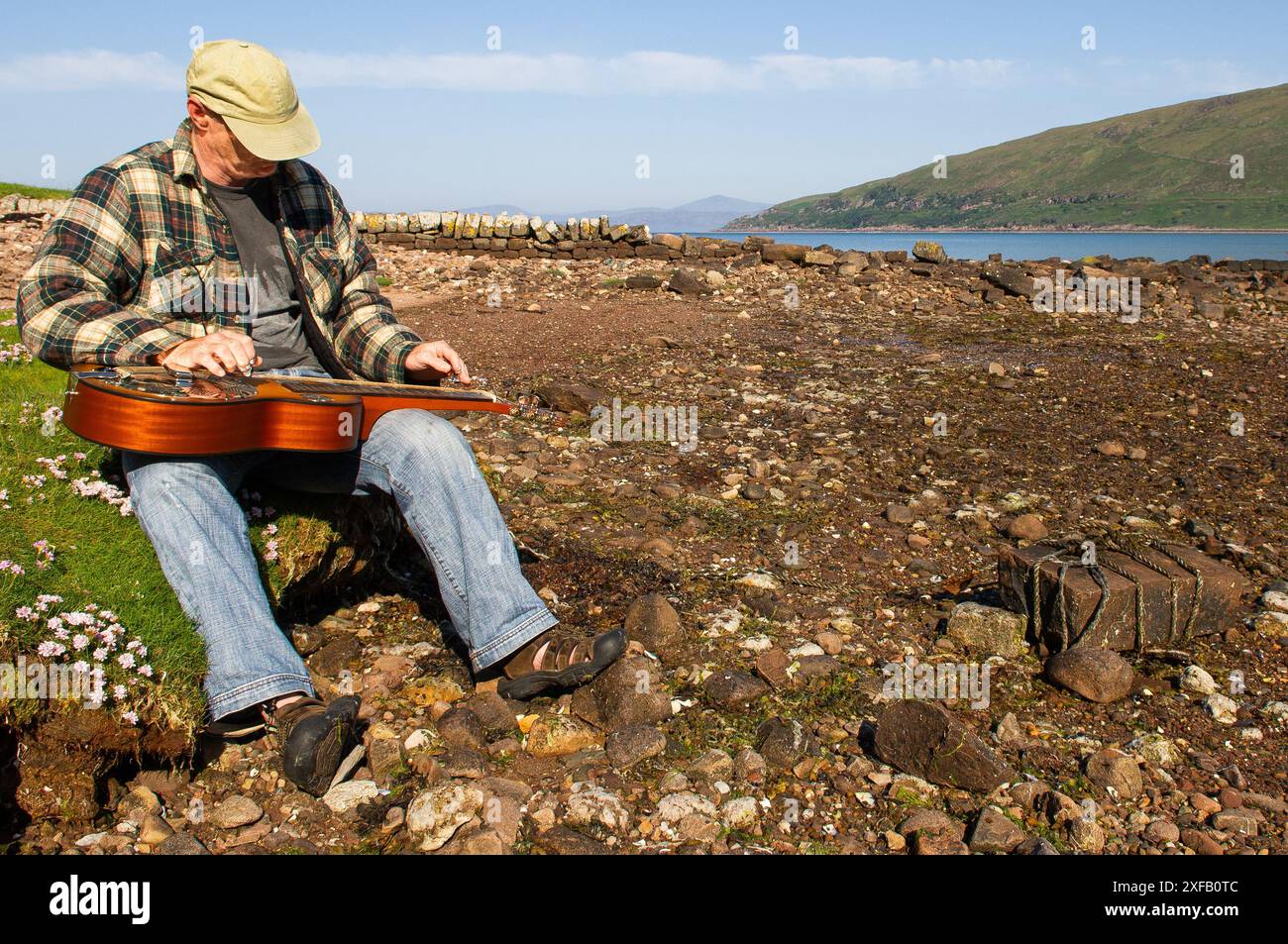 Robin Clark owner of Busker Guitars plays one of Busker guitars ...