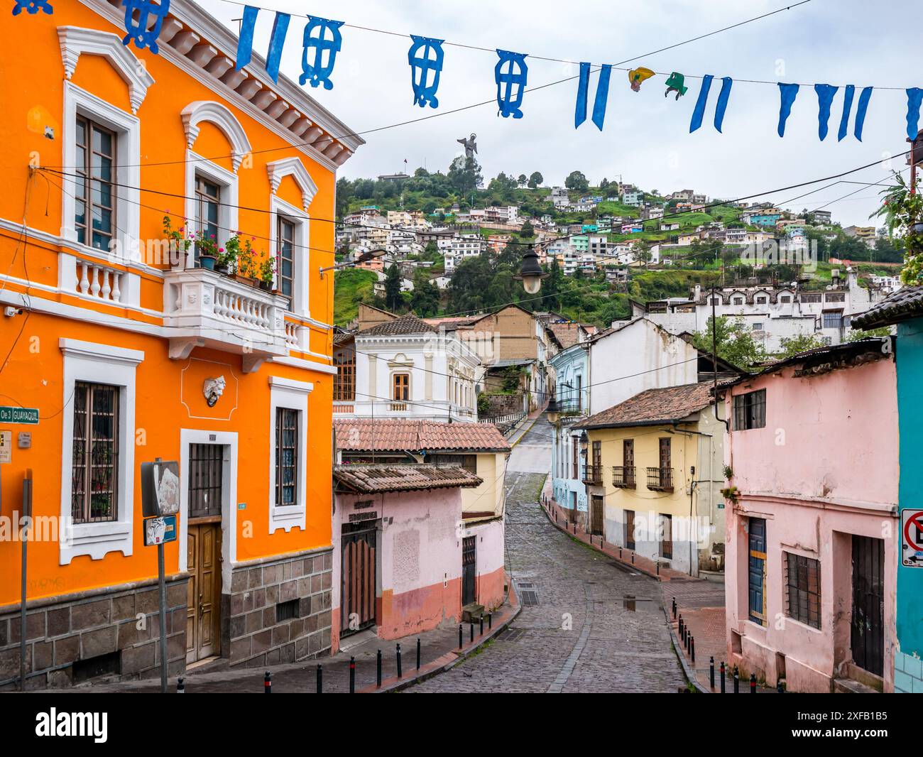Colourful orange colonial style building on narrow street, Quito Old ...