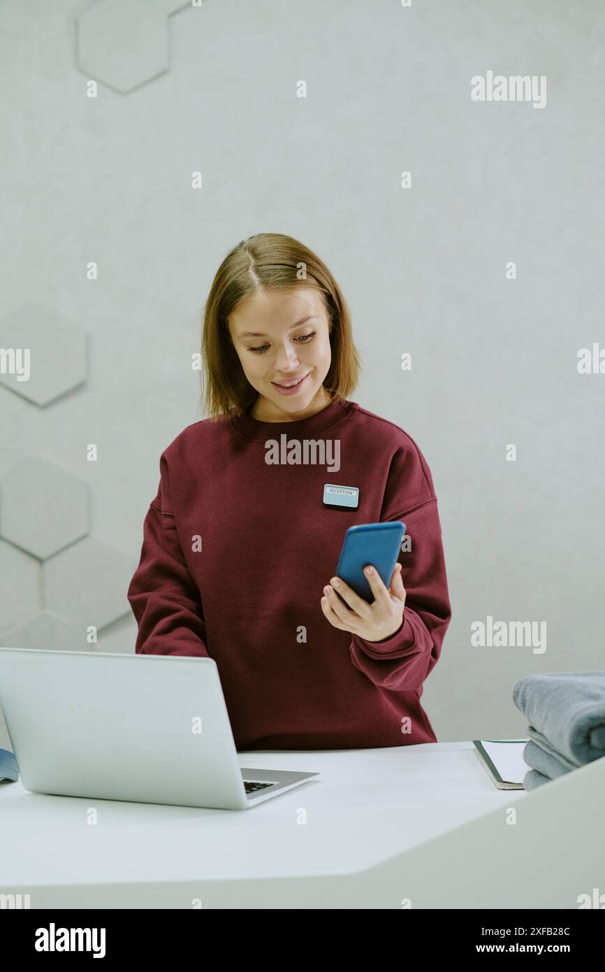 Pretty female receptionist making video call while she at work and ...