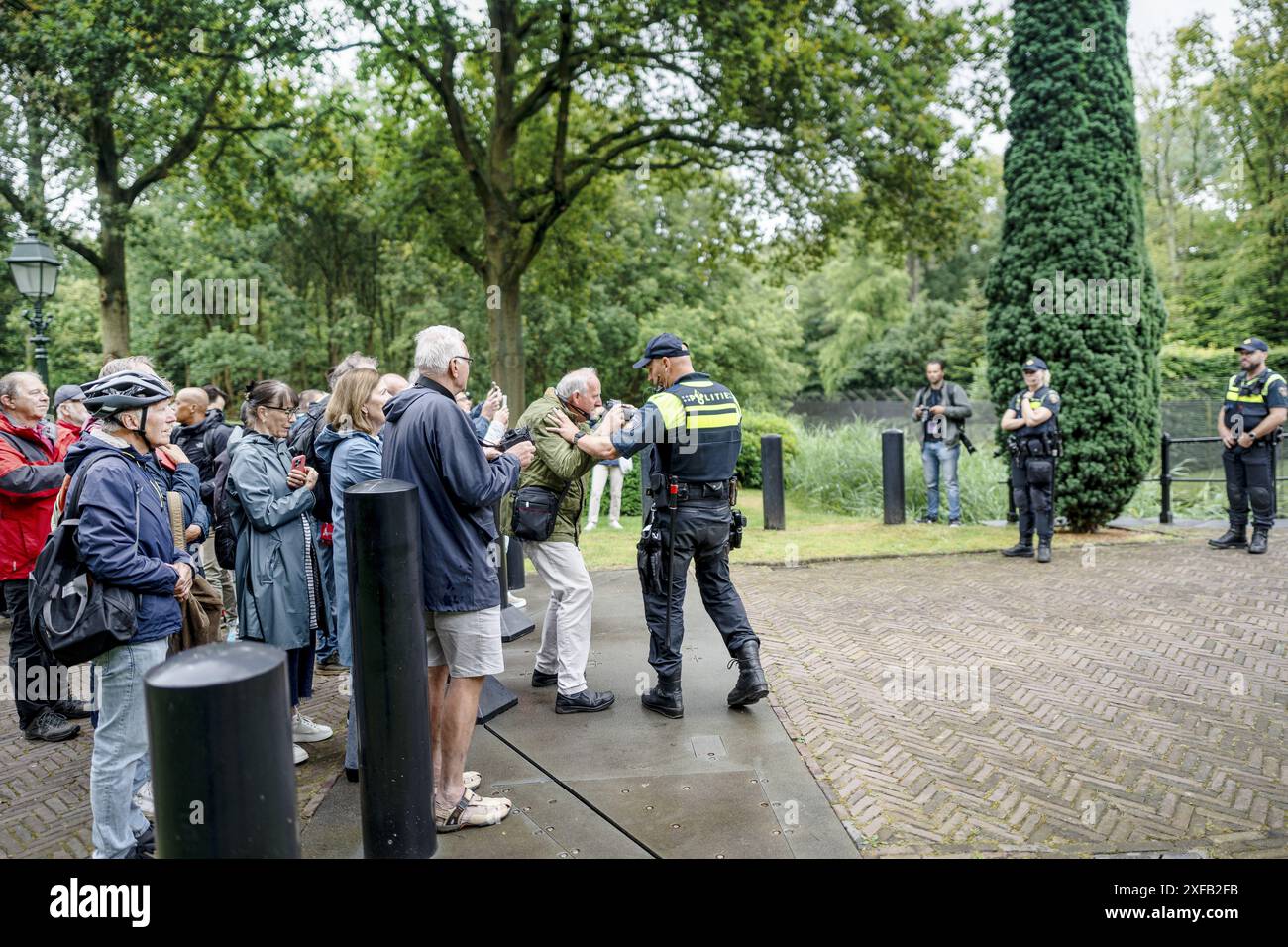 THE HAGUE - A police officer keeps an interested party at a distance at ...