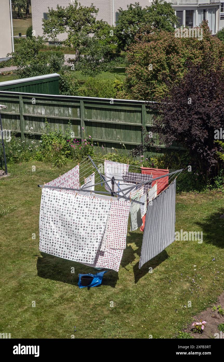 Drying rack with laundry drying out in the garden to save energy by not ...
