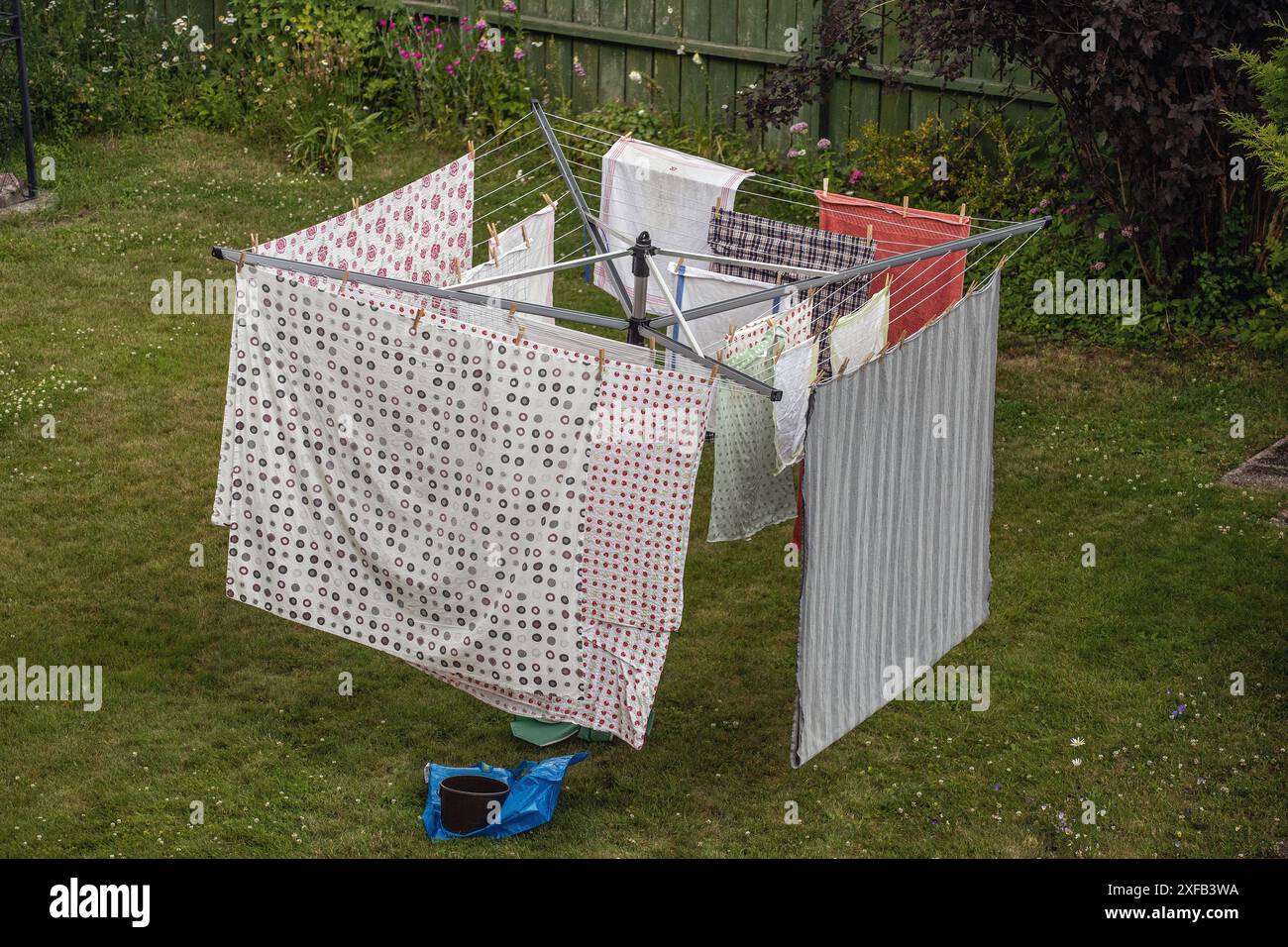 Drying rack with laundry drying out in the garden to save energy by not ...