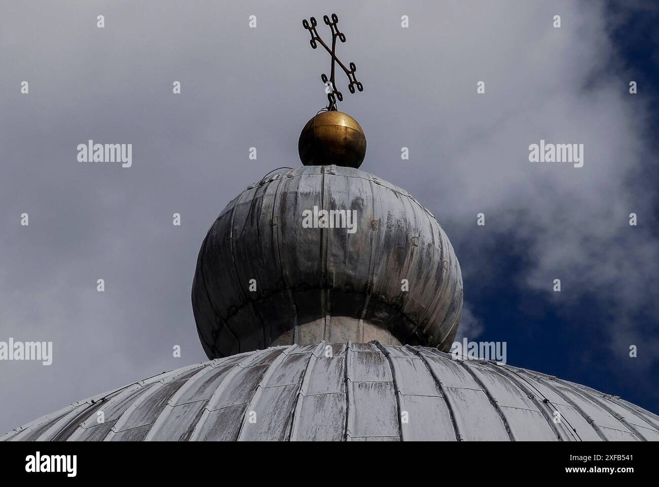Cross springs from golden ball surmounting the lead-sheathed dome of ...