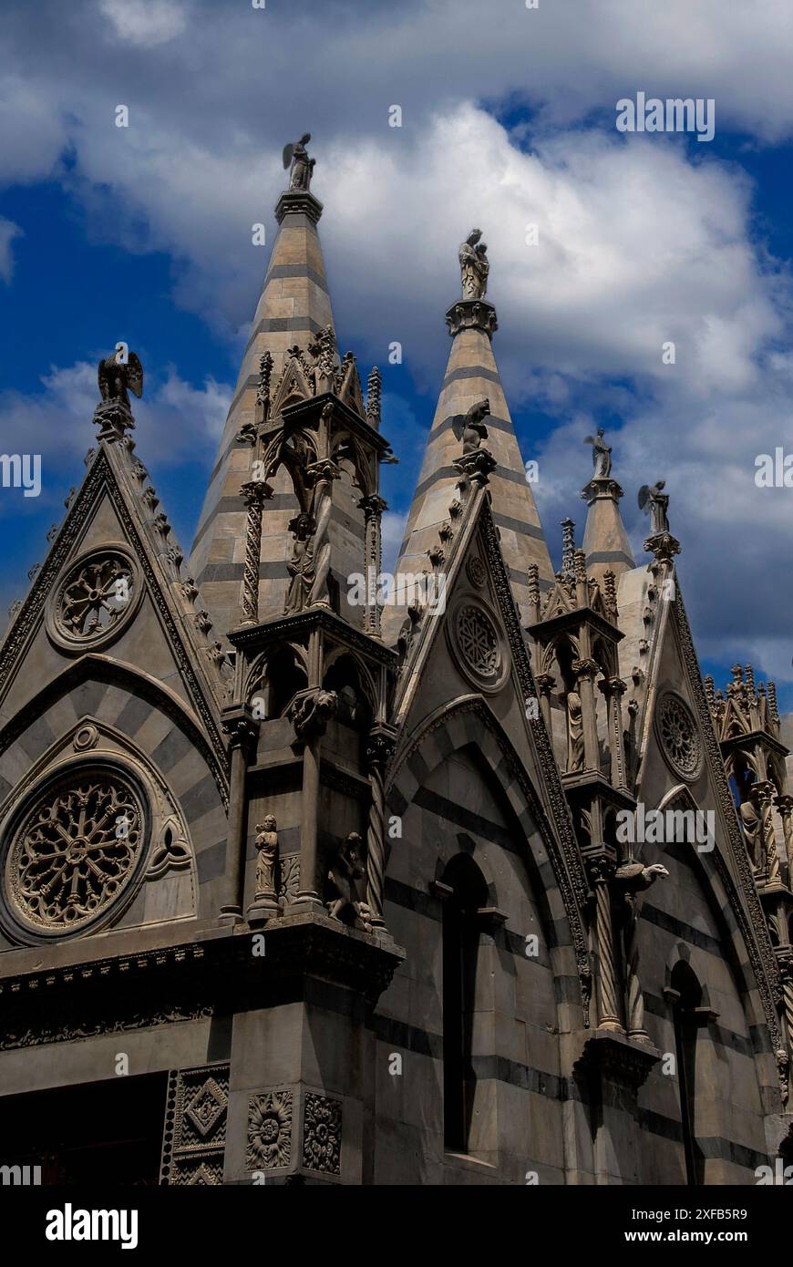 Three pyramidal spires soar above a Pisan Gothic church, the Chiesa di ...