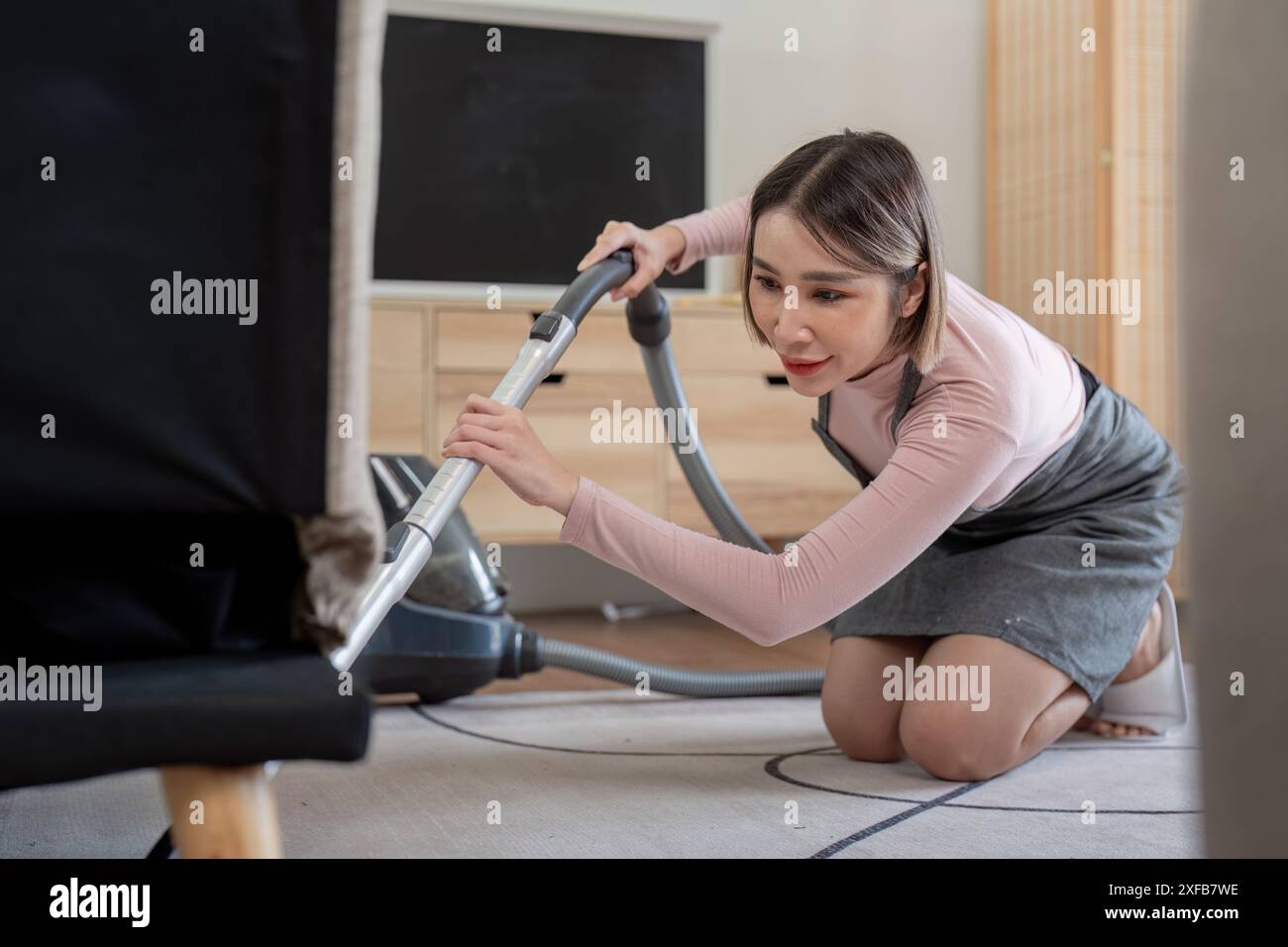 Housekeeper Cleaning Living Room with Vacuum Cleaner, Performing ...