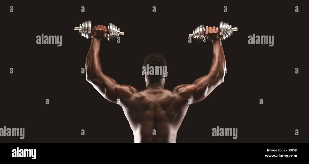 Man Lifting Dumbbells With Back Muscles Flexed Stock Photo - Alamy