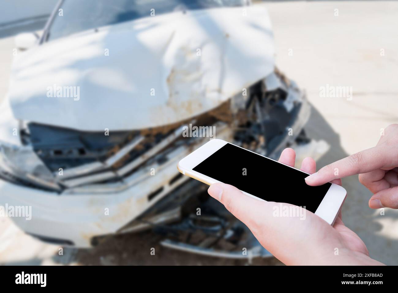 Female using mobile smart phone taking photo of the car crash accident ...