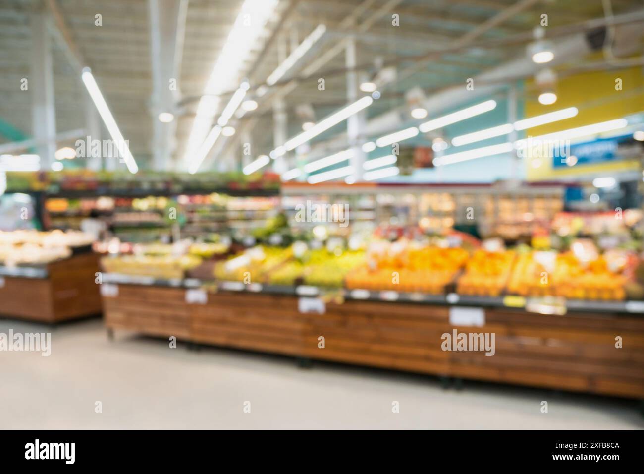 Supermarket grocery store with fruit and vegetable on shelves blurred ...