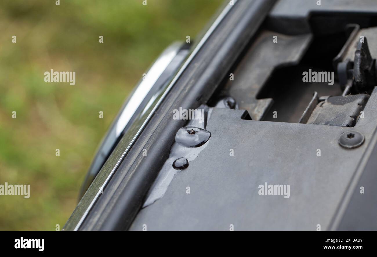 A leak of technical fluid in the engine compartment of the car. Car ...