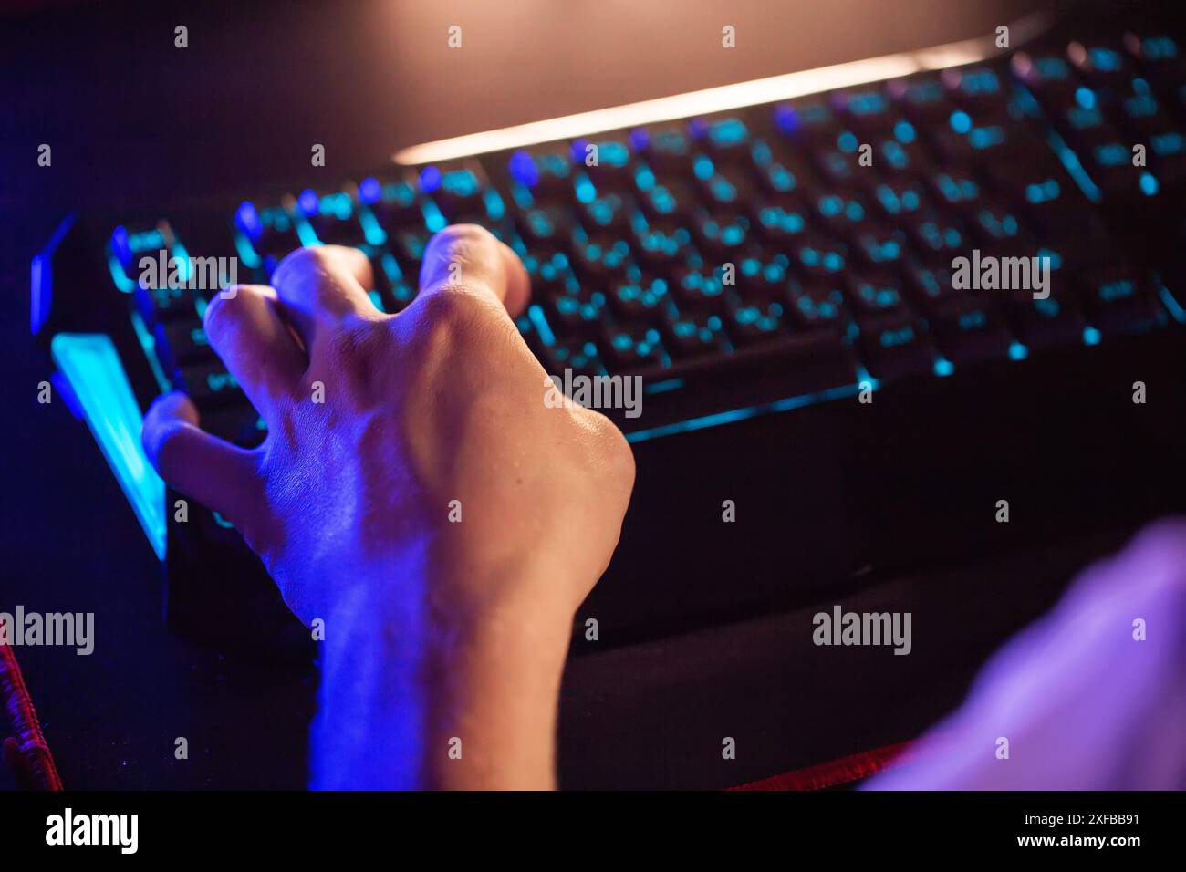 Gamers play video game on PC at computer club. Finger clicks on button ...