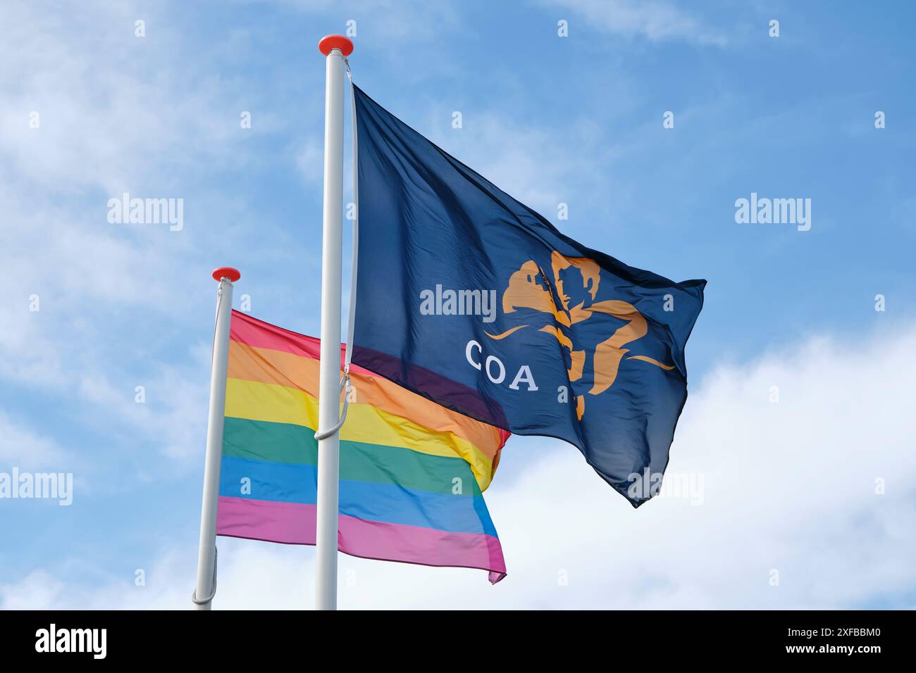 Flag of the COA and a rainbow flag at the entrance of a temporary ...